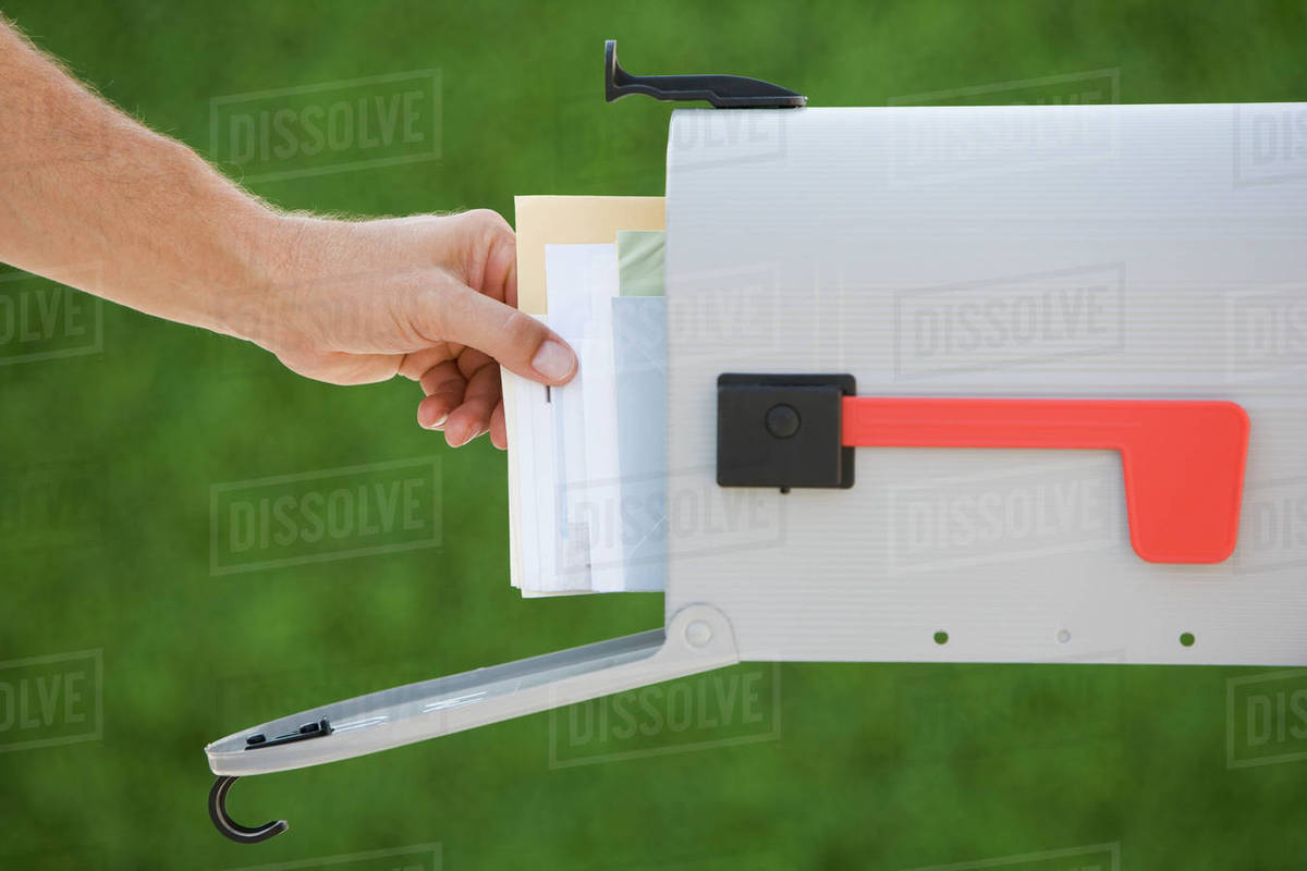 Man taking mail out of mailbox - Royalty-free Stock Photo | Dissolve