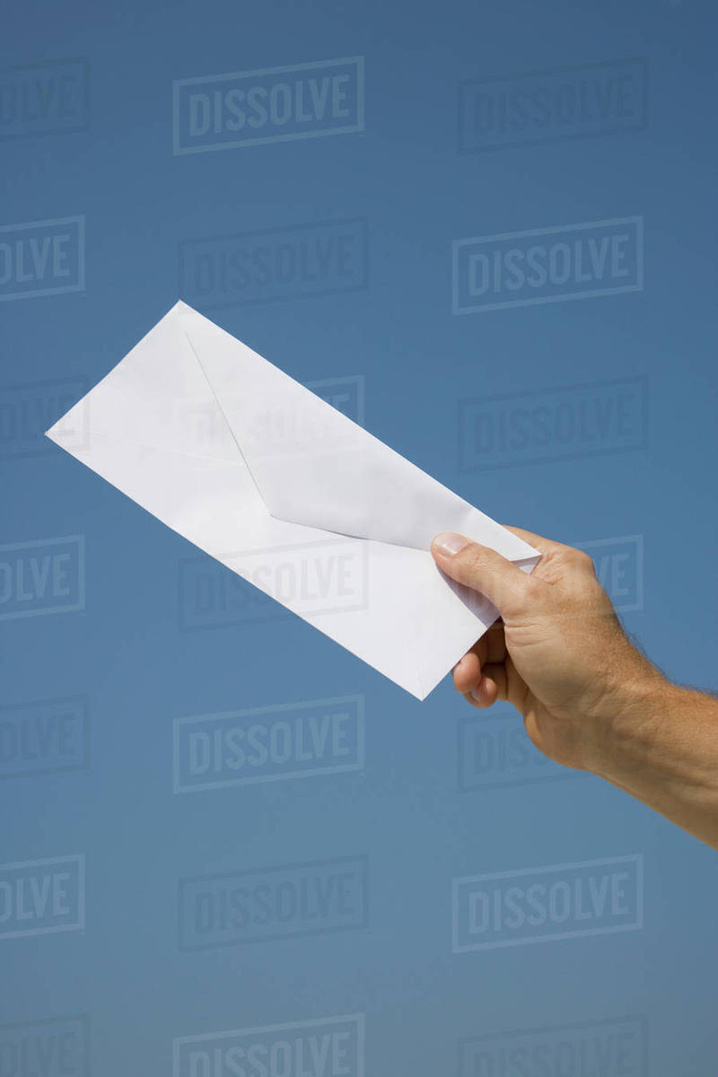 Man holding envelope - Stock Photo - Dissolve