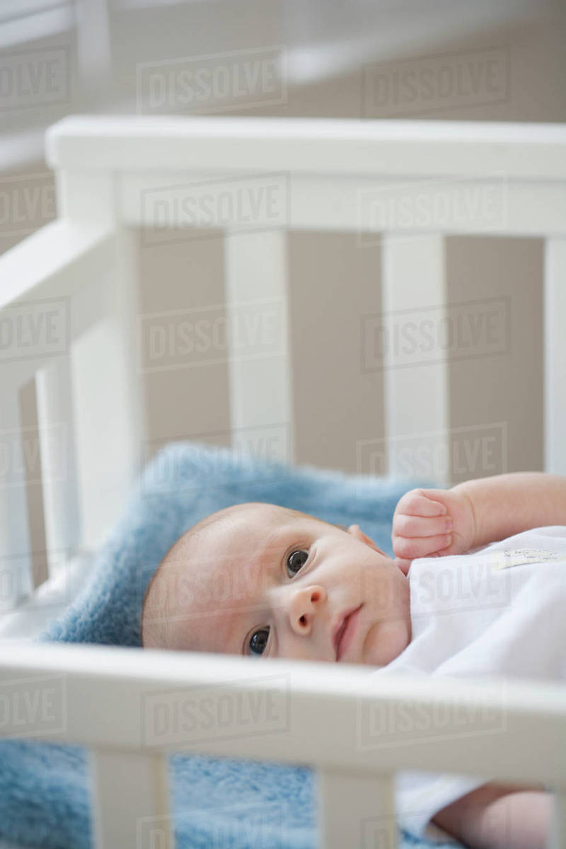 Baby laying in crib - Royalty-free Stock Photo | Dissolve