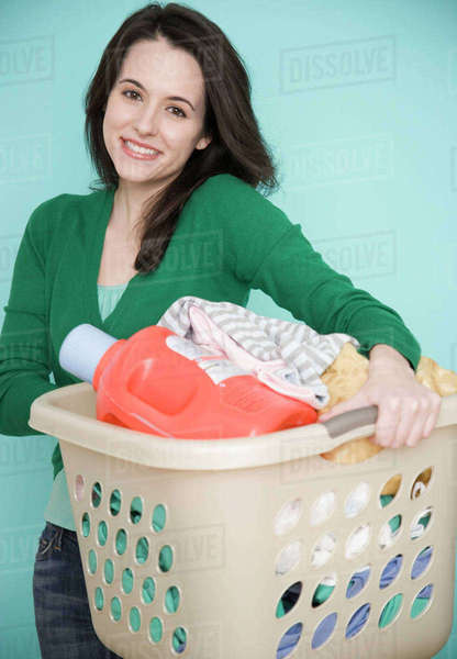 Portrait of woman carrying laundry basket - Royalty-free Stock Photo ...