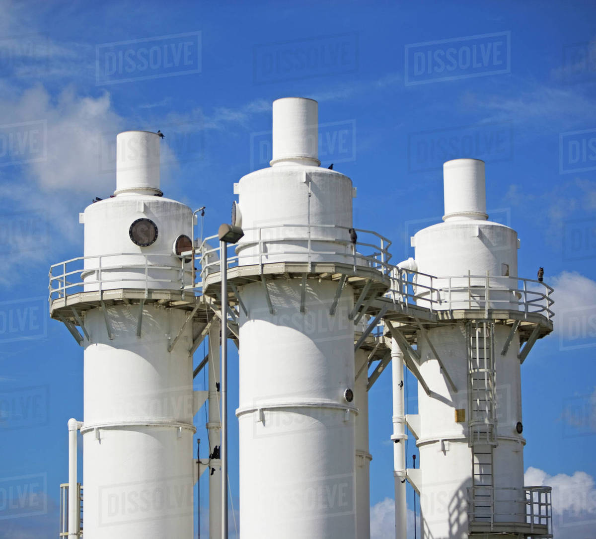 Metal silos under blue sky - Royalty-free Stock Photo | Dissolve