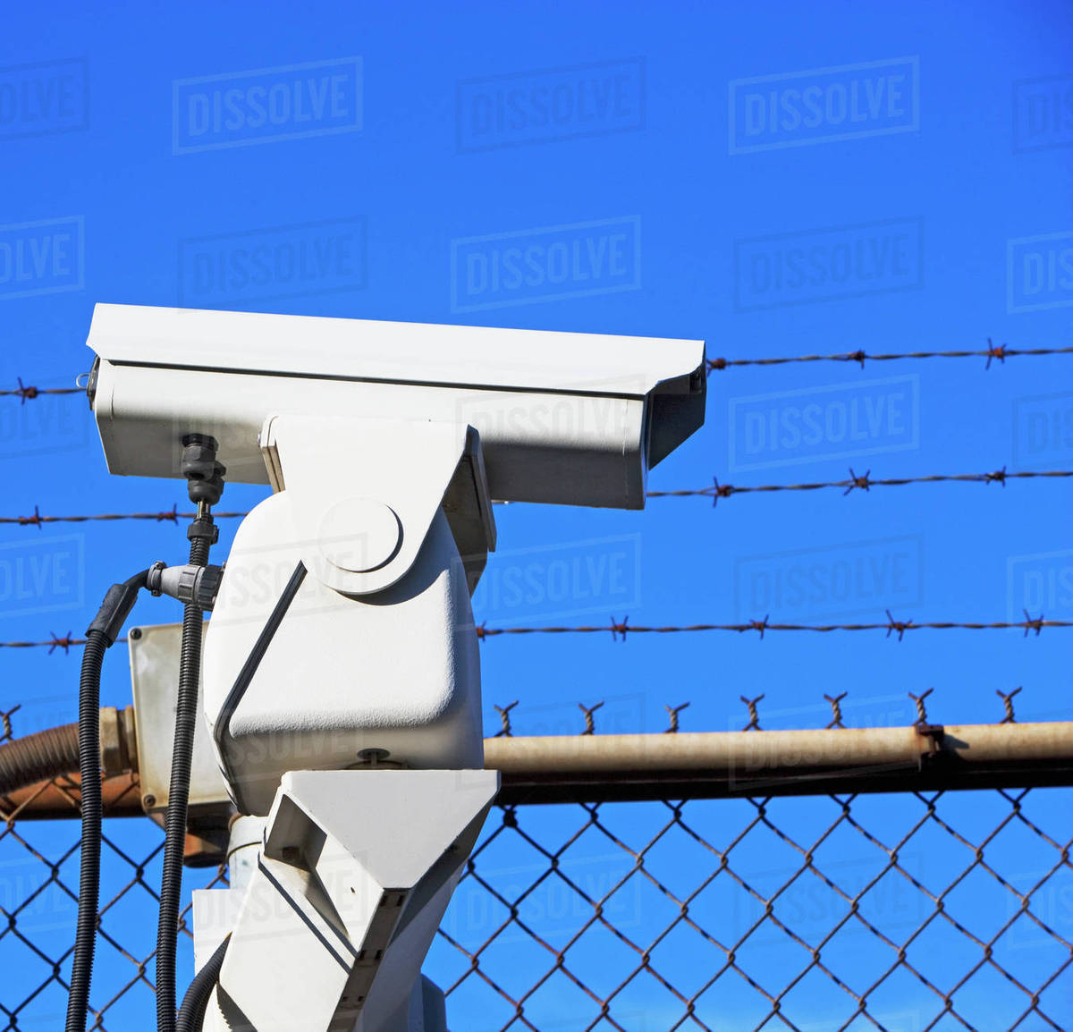 Security camera on fence - Royalty-free Stock Photo | Dissolve