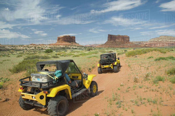 Off-road vehicles driving through desert - Stock Photo - Dissolve
