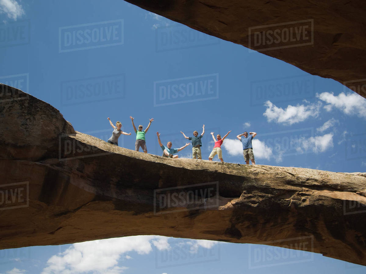 People cheering on rock formation - Royalty-free Stock Photo | Dissolve
