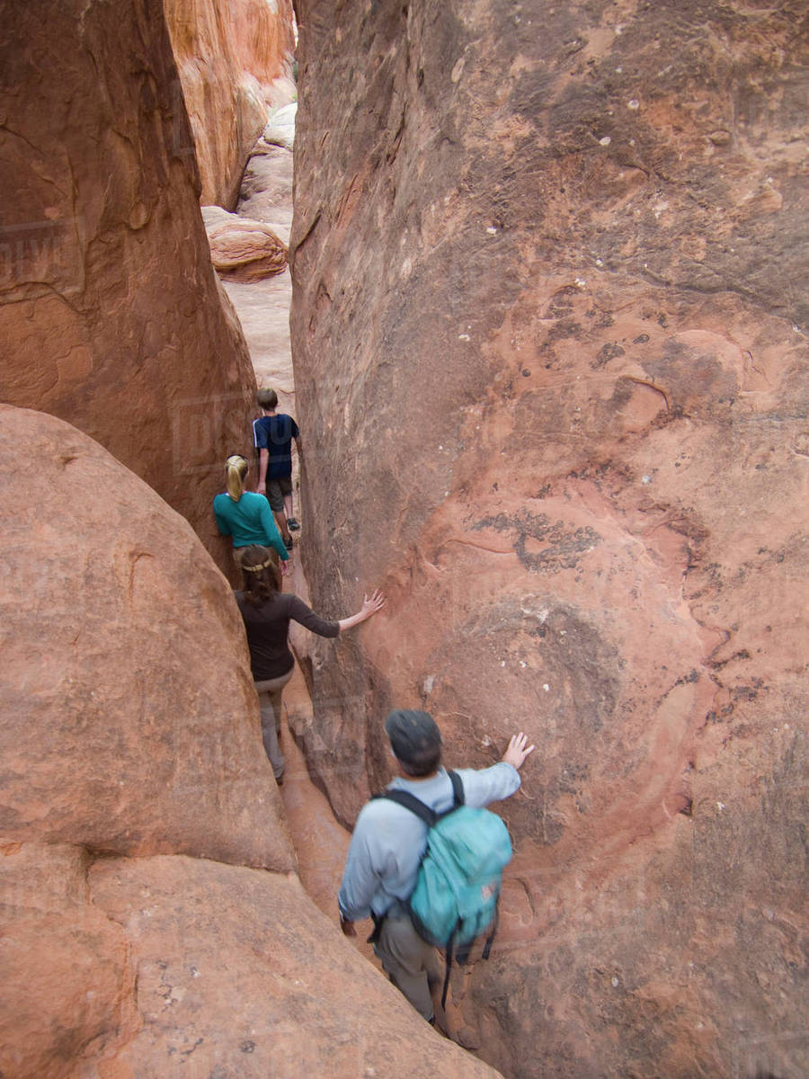 People walking through rock formations - Stock Photo - Dissolve