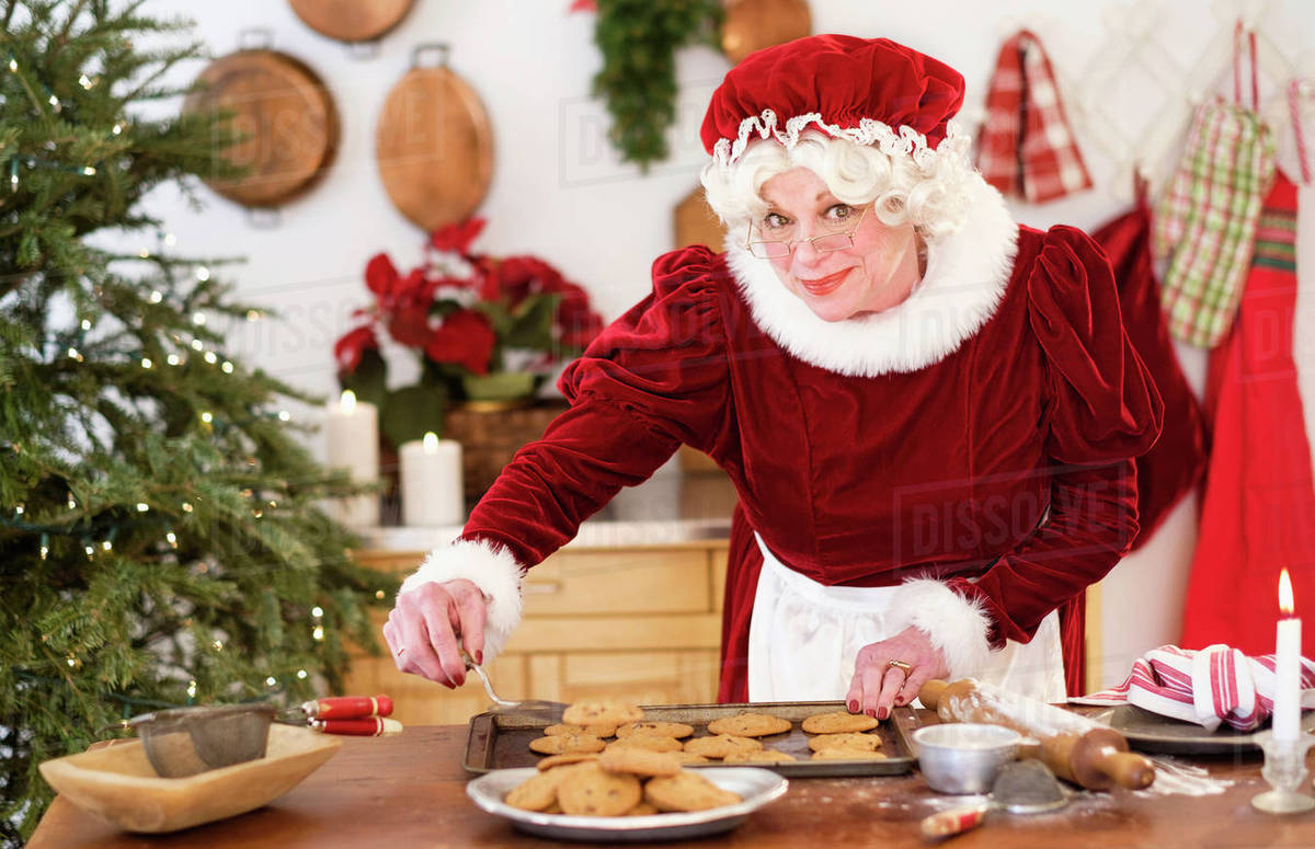 Mrs. Claus making gingerbread cookies - Royalty-free Stock Photo | Dissolve