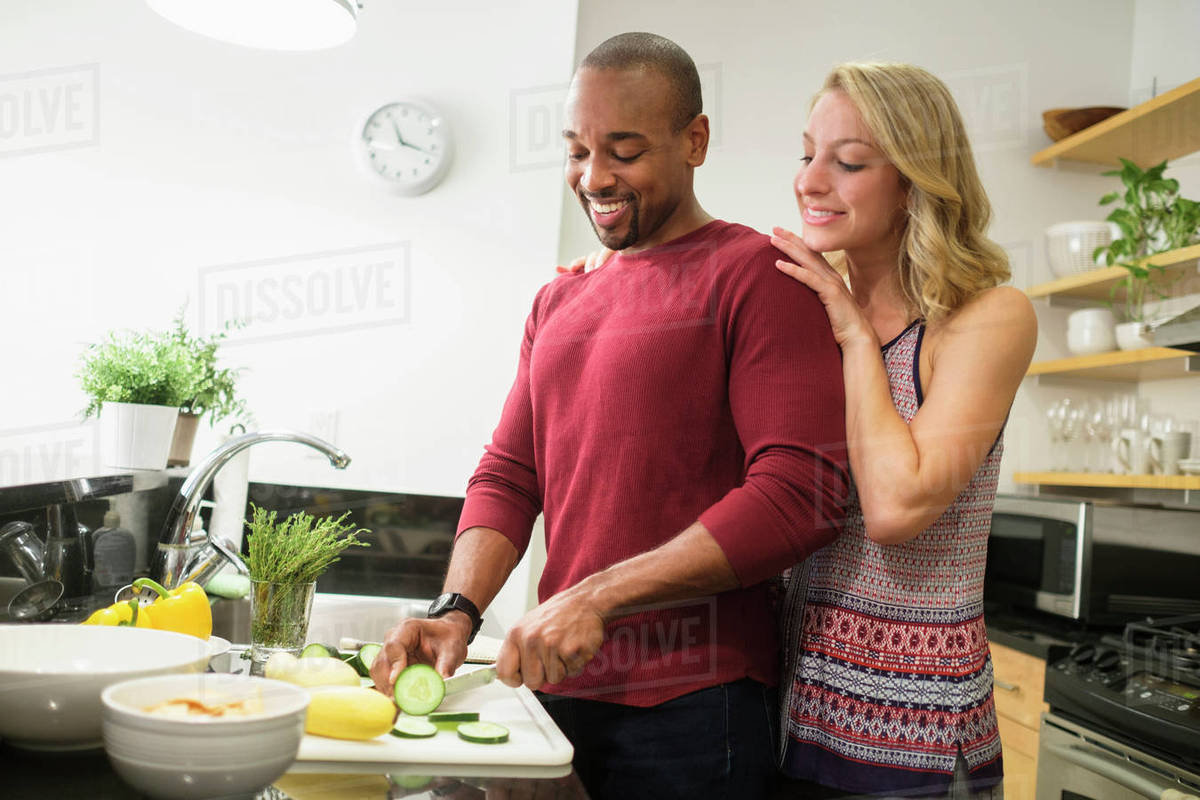Couple preparing dinner in kitchen - Stock Photo - Dissolve