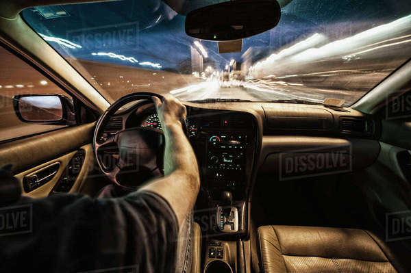 Interior of car driving through city streets at dusk - Royalty-free ...