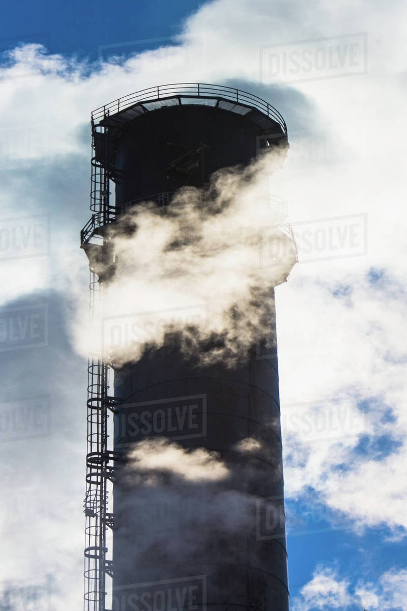 Smokestack releasing smoke - Stock Photo - Dissolve