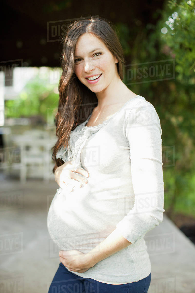 Portrait of pregnant mid adult woman - Royalty-free Stock Photo | Dissolve