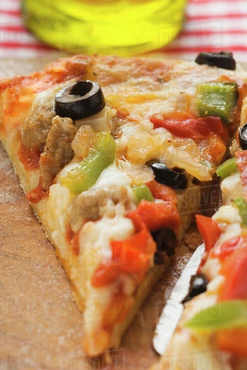 Piece of pepperoni pizza with peppers and olives - Royalty-free Stock ...