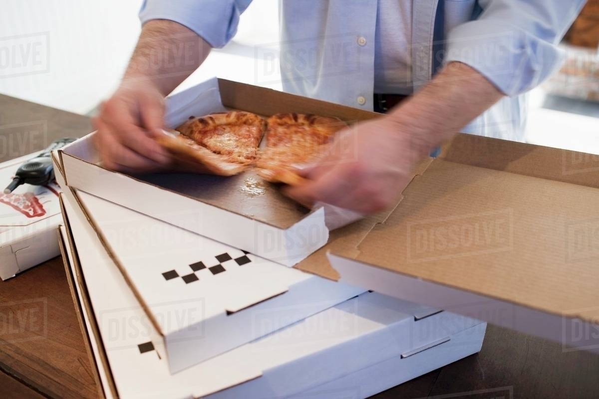Man dividing up Pizza Margherita in pizza box - Royalty-free Stock ...