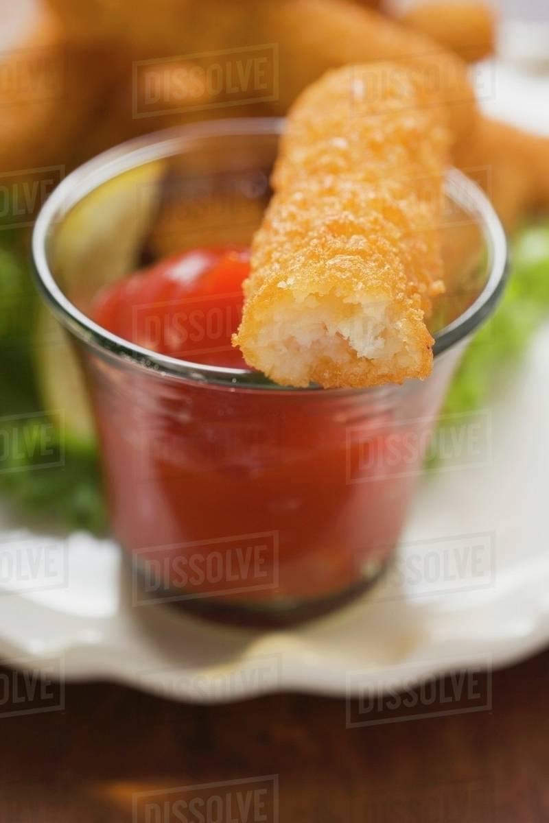 Fish finger with ketchup (a bite taken) - Royalty-free Stock Photo ...