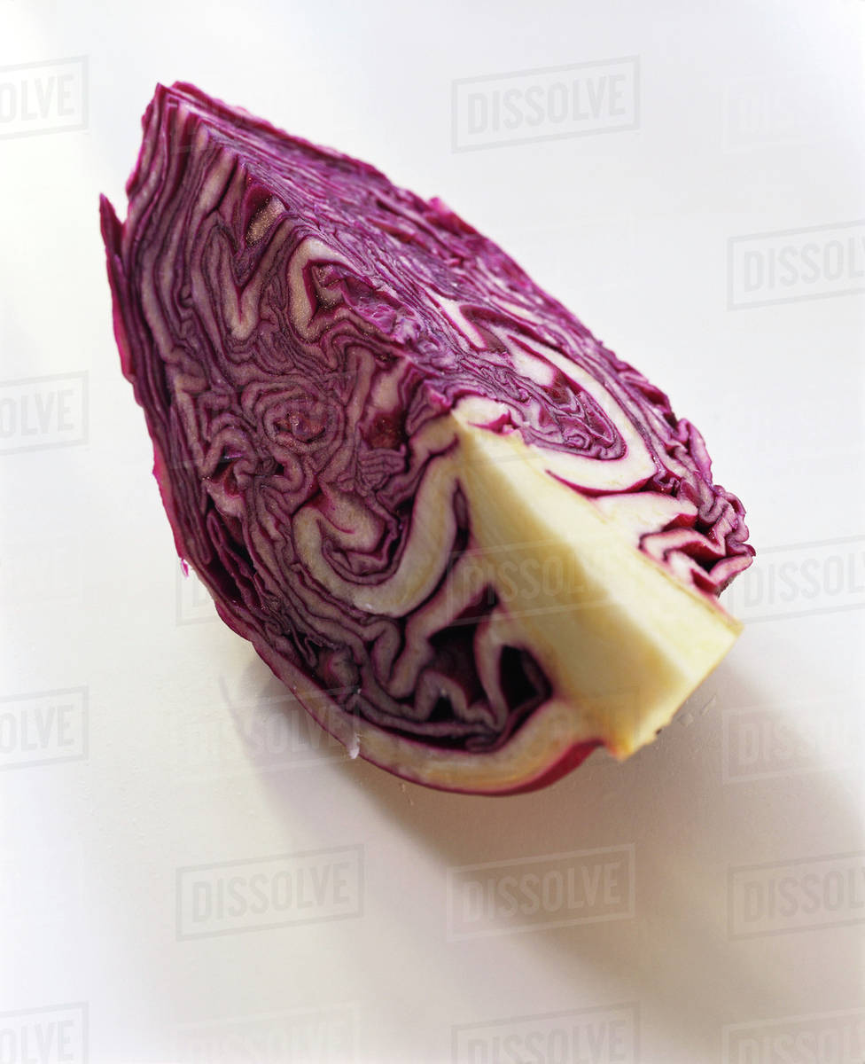 A quarter of a red cabbage on white background - Stock Photo - Dissolve