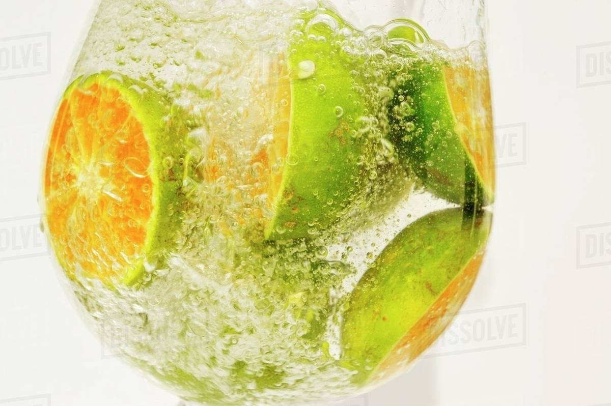 Citrus fruits in a glass of water - Stock Photo - Dissolve