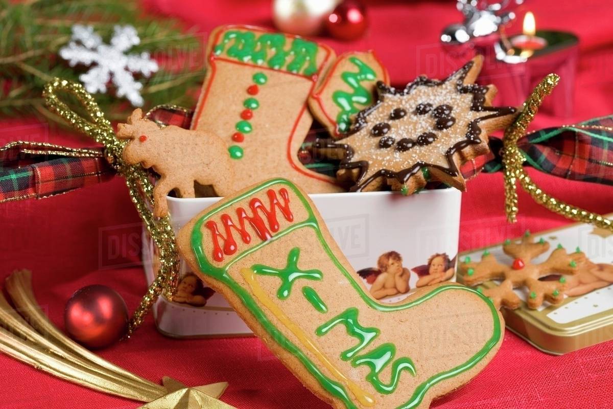 Various Christmas biscuits in a biscuit tin - Stock Photo - Dissolve