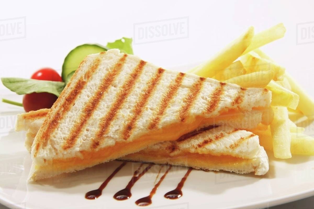 Toasted cheese sandwich with chips, balsamic vinegar and a salad ...