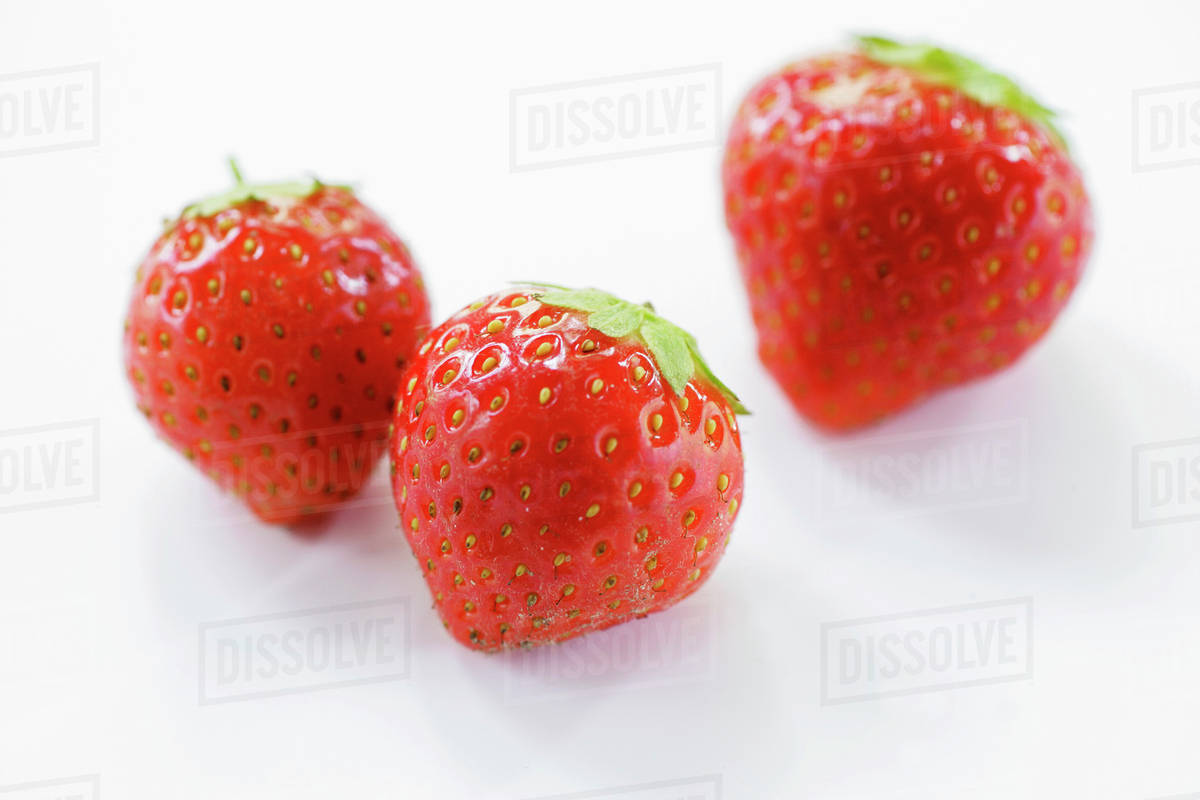Three strawberries - Stock Photo - Dissolve