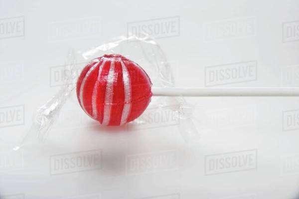 Red lollipop, unwrapped - Royalty-free Stock Photo | Dissolve