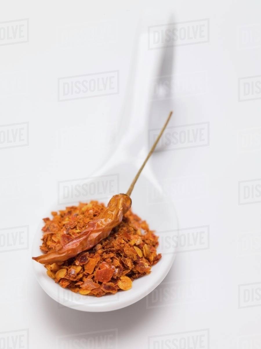 Chilli flakes and dried chilli on spoon - Royalty-free Stock Photo ...