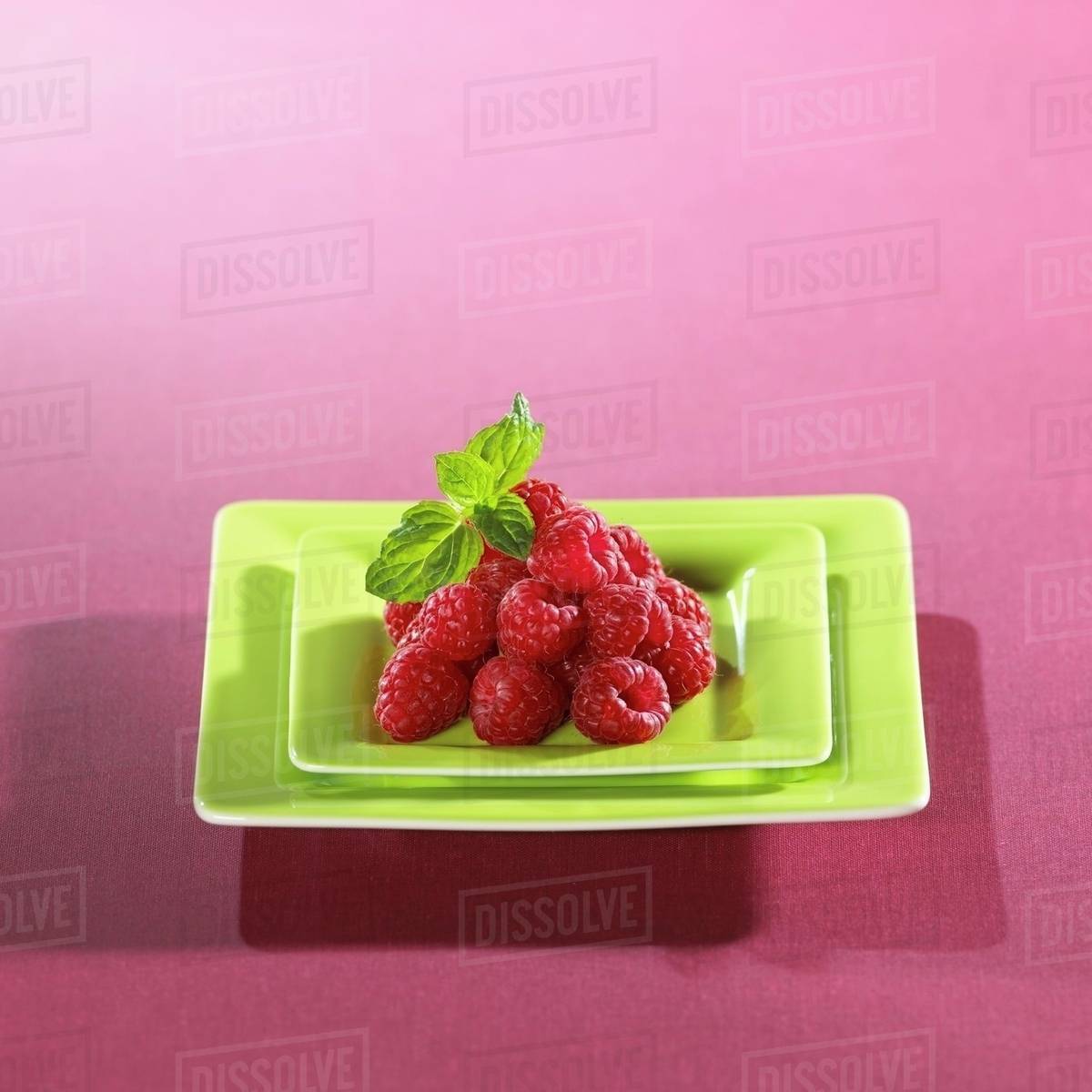 Fresh raspberries in square green dish - Royalty-free Stock Photo ...