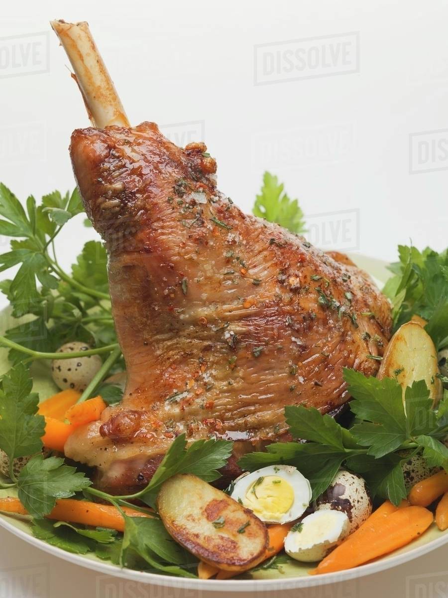 Lamb shank with quails' eggs, carrots and parsley for Easter - Stock ...