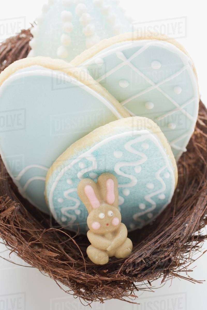 Biscuits and marzipan rabbit in Easter nest - Stock Photo - Dissolve