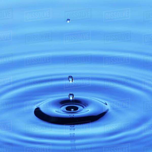 Drops of water falling into water - Royalty-free Stock Photo | Dissolve