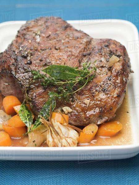 Boned leg of wild boar with carrots - Royalty-free Stock Photo | Dissolve