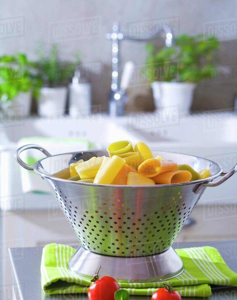 Cooked pasta in a colander - Stock Photo - Dissolve