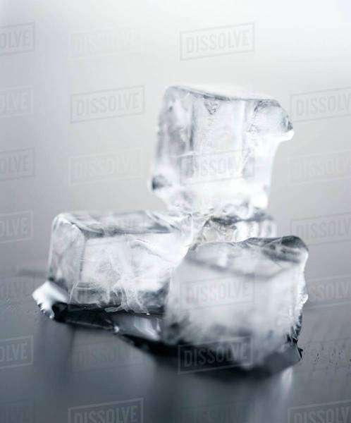Three melting ice cubes - Royalty-free Stock Photo | Dissolve