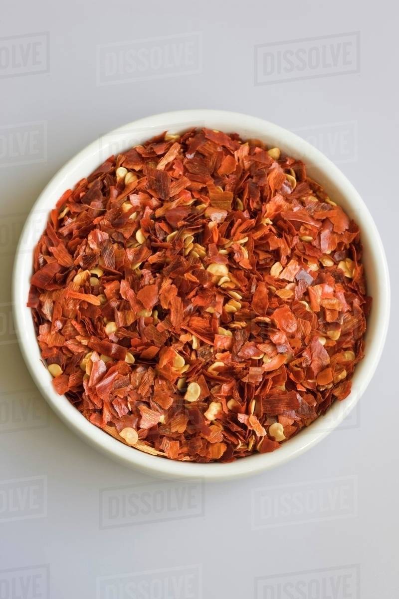 Dried chilli flakes in small white bowl - Royalty-free Stock Photo ...