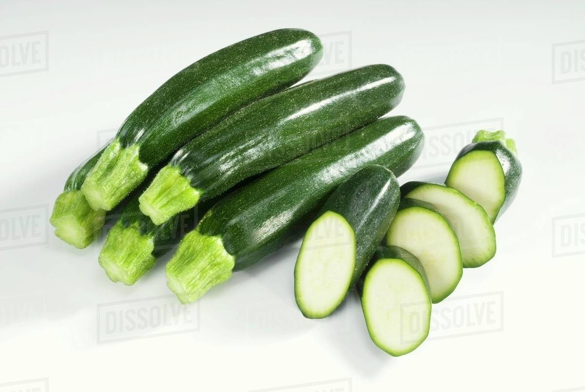 Several whole and one sliced courgette - Royalty-free Stock Photo ...