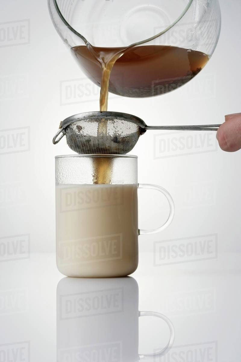 Straining Yogi tea into a tea glass - Royalty-free Stock Photo | Dissolve