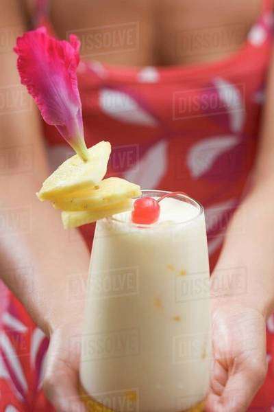 Woman serving Pina Colada - Royalty-free Stock Photo | Dissolve