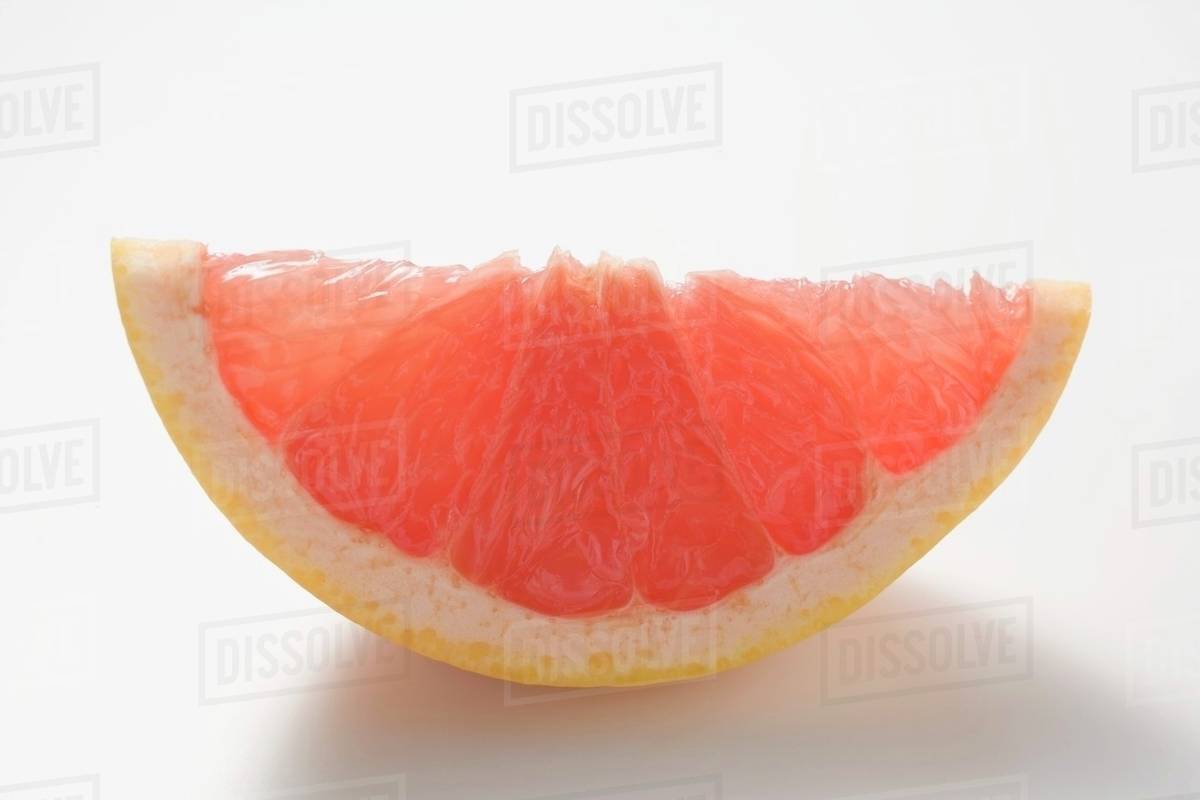 Wedge of pink grapefruit - Stock Photo - Dissolve