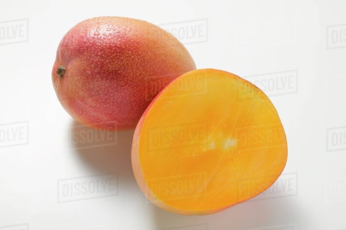 Whole mango and half a mango - Stock Photo - Dissolve