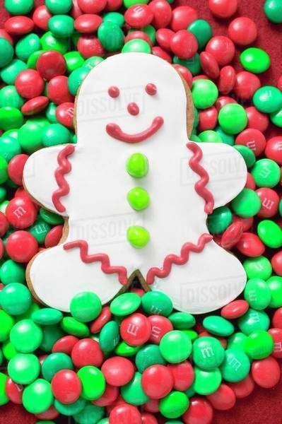 White gingerbread man on red and green chocolate beans - Royalty-free ...