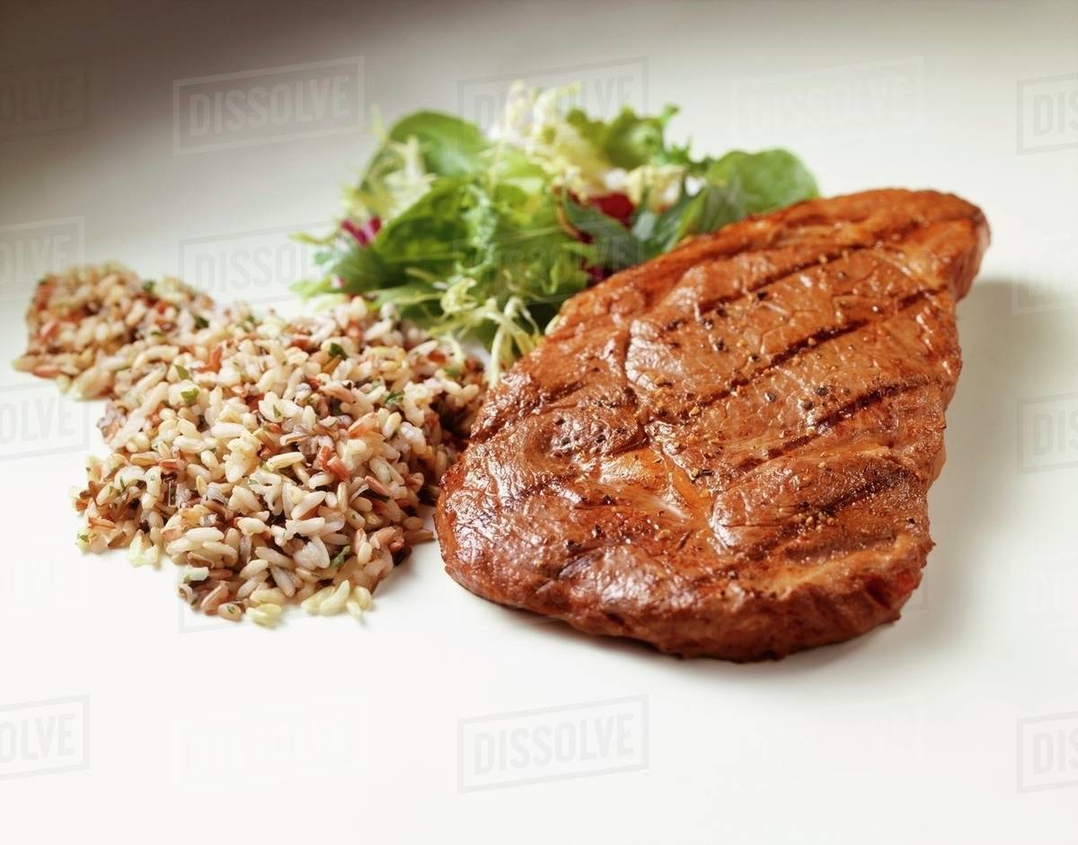 Grilled Steak with Wild Rice and Salad on White - Royalty-free Stock ...