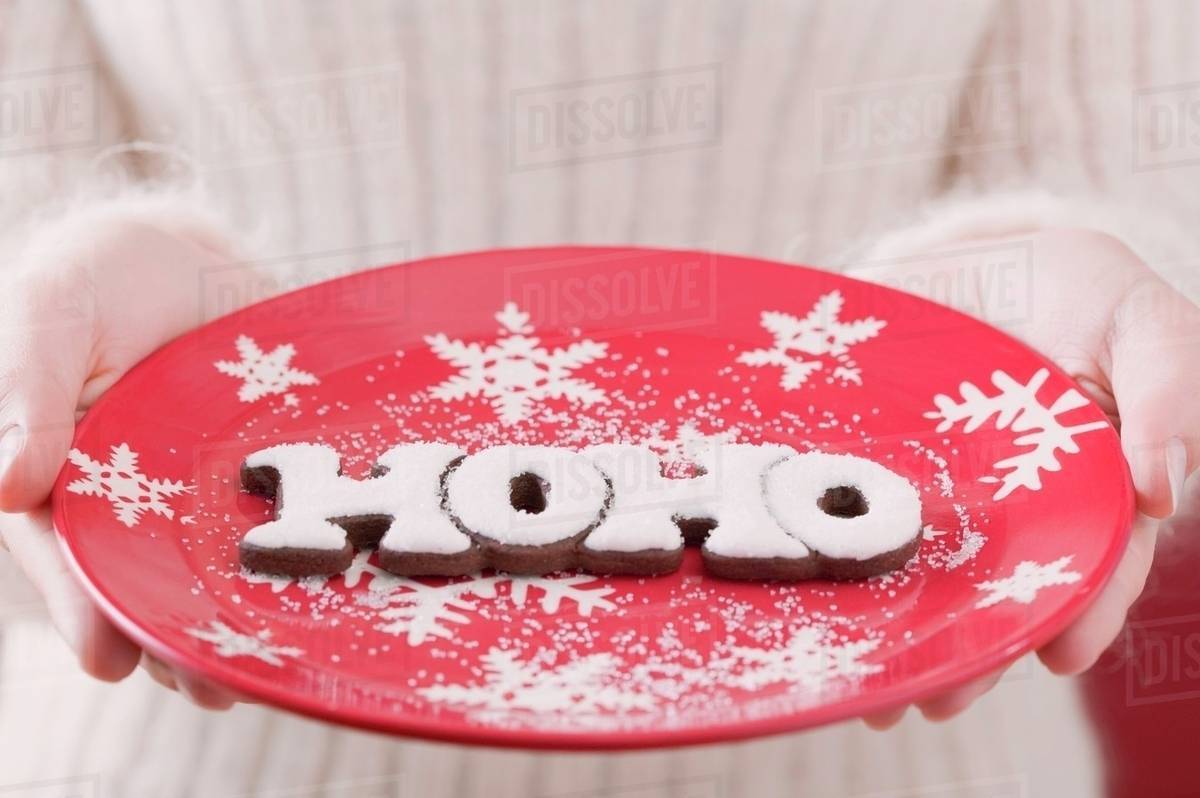 Hands holding festive plate with the word HOHO - Royalty-free Stock ...