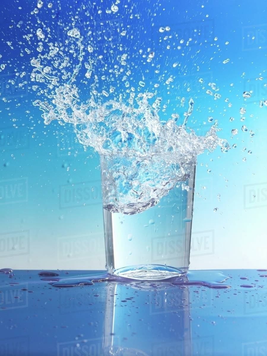 Water splashing out of glass - Royalty-free Stock Photo | Dissolve