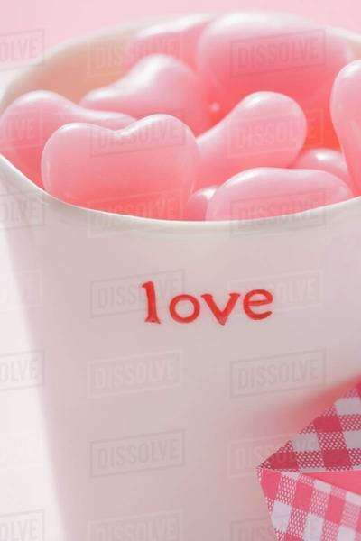 Pink heart-shaped sweets in beaker for Valentine's Day - Royalty-free ...