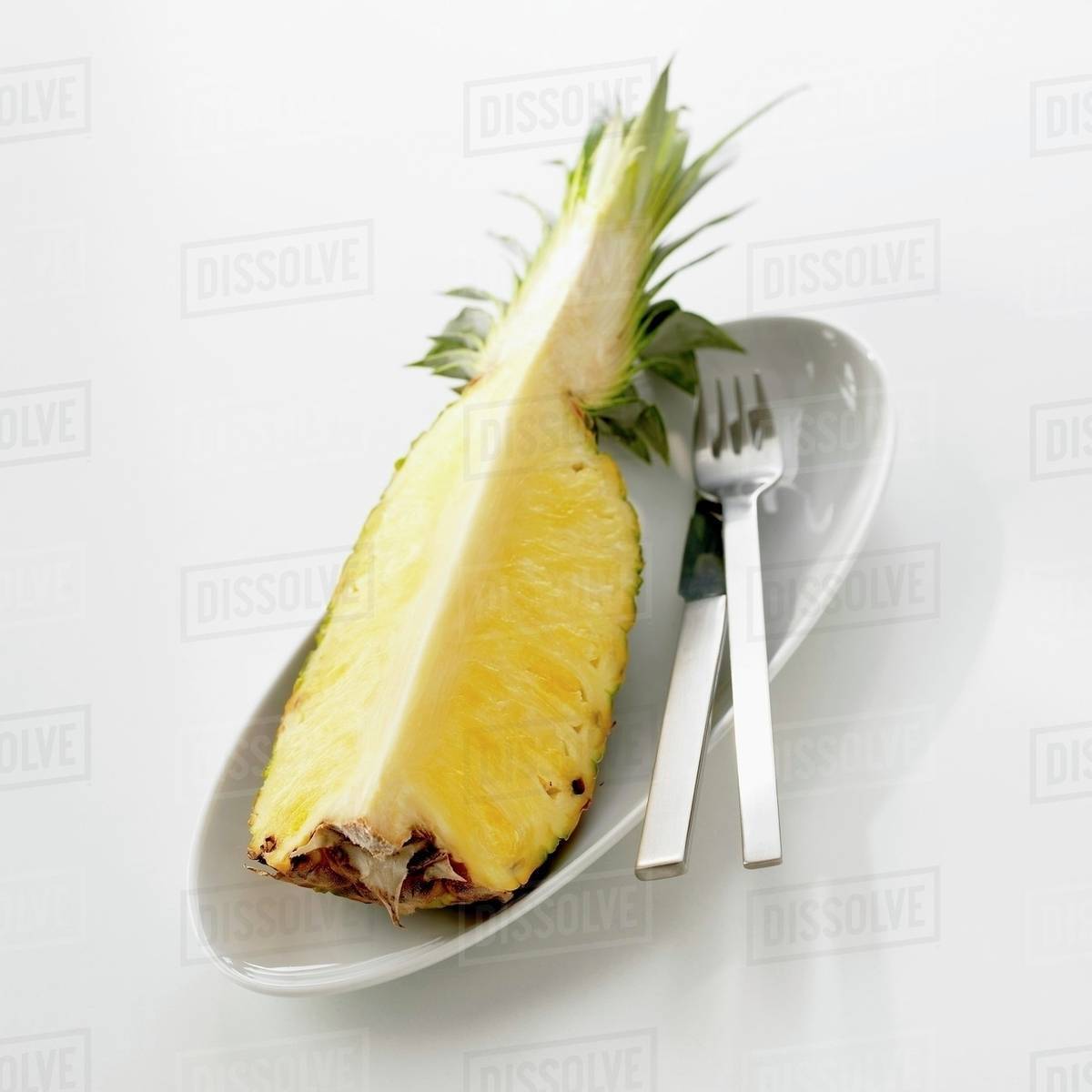 Pineapple quarter in dish with knife and fork - Royalty-free Stock ...