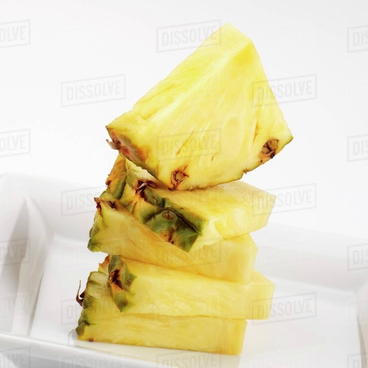 Pineapple quarters, stacked in white dish - Royalty-free Stock Photo ...