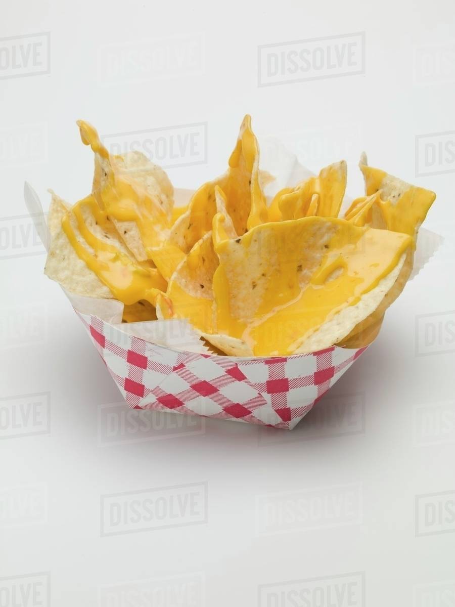 Nachos with cheese sauce in paper dish - Royalty-free Stock Photo ...