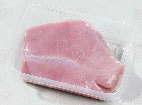 Fresh turkey fillet in plastic container - Stock Photo - Dissolve