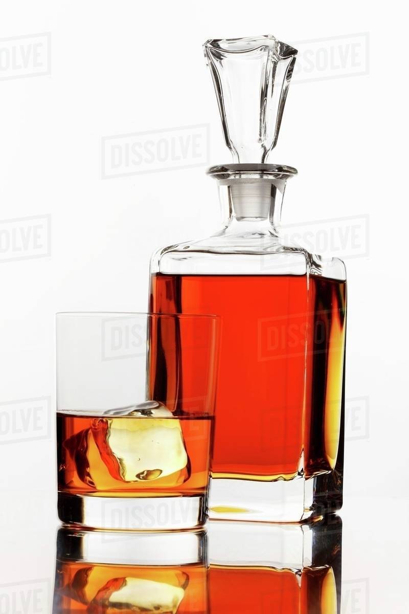 Whiskey in a glass and a bottle on a white surface - Royalty-free Stock ...