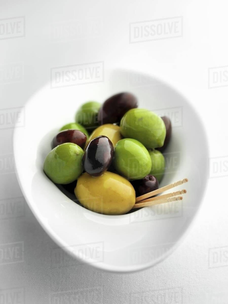 Mixed olives with toothpicks - Royalty-free Stock Photo | Dissolve