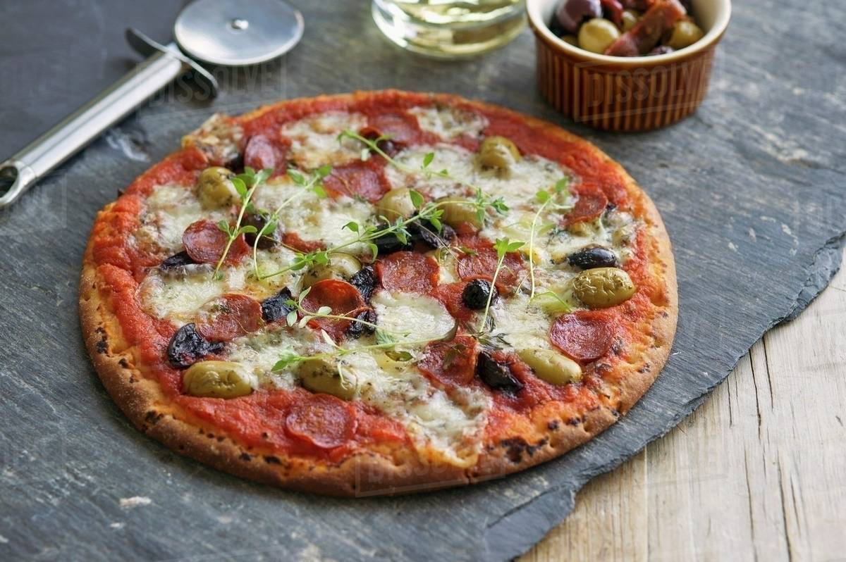 Chorizo, mozzarella and olive pizza - Stock Photo - Dissolve