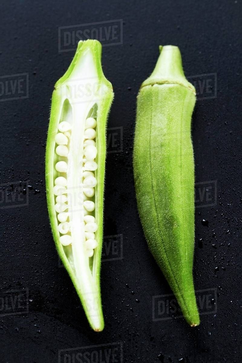 Okra pods, whole and halved - Royalty-free Stock Photo | Dissolve